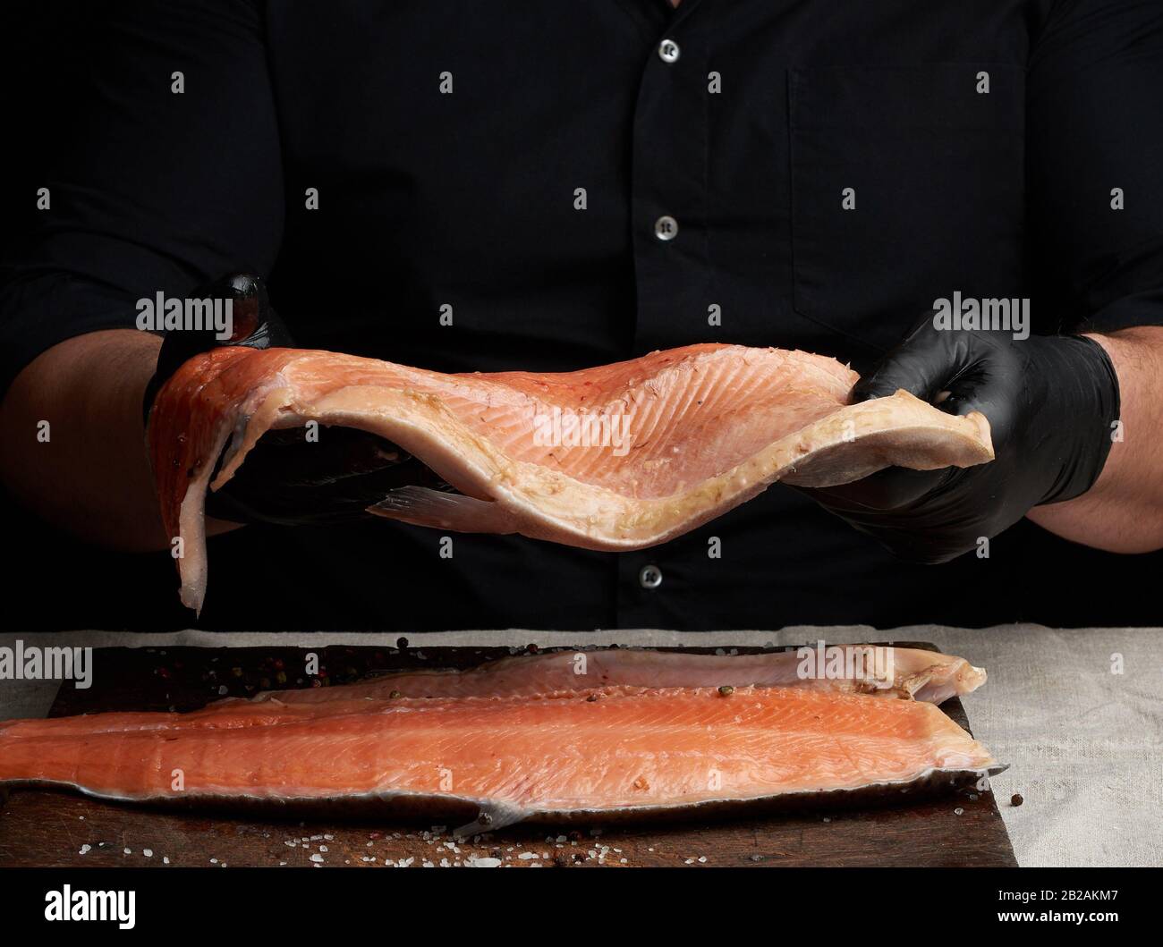 Chef holding steak dinner and salmon dinner in a commercial kitchen ...