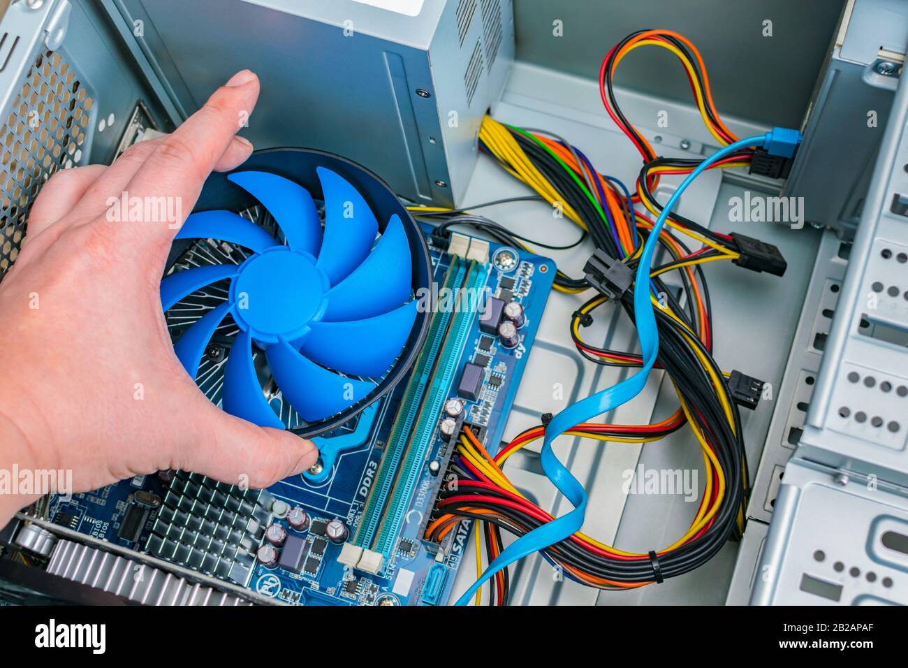 Installing a processor fan on the computer motherboard. Computer repair, PC assembly Stock Photo ...