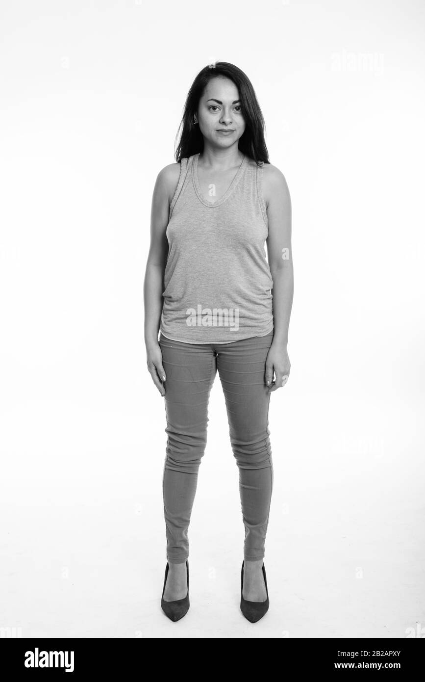 Full body shot of beautiful woman standing against white background ...