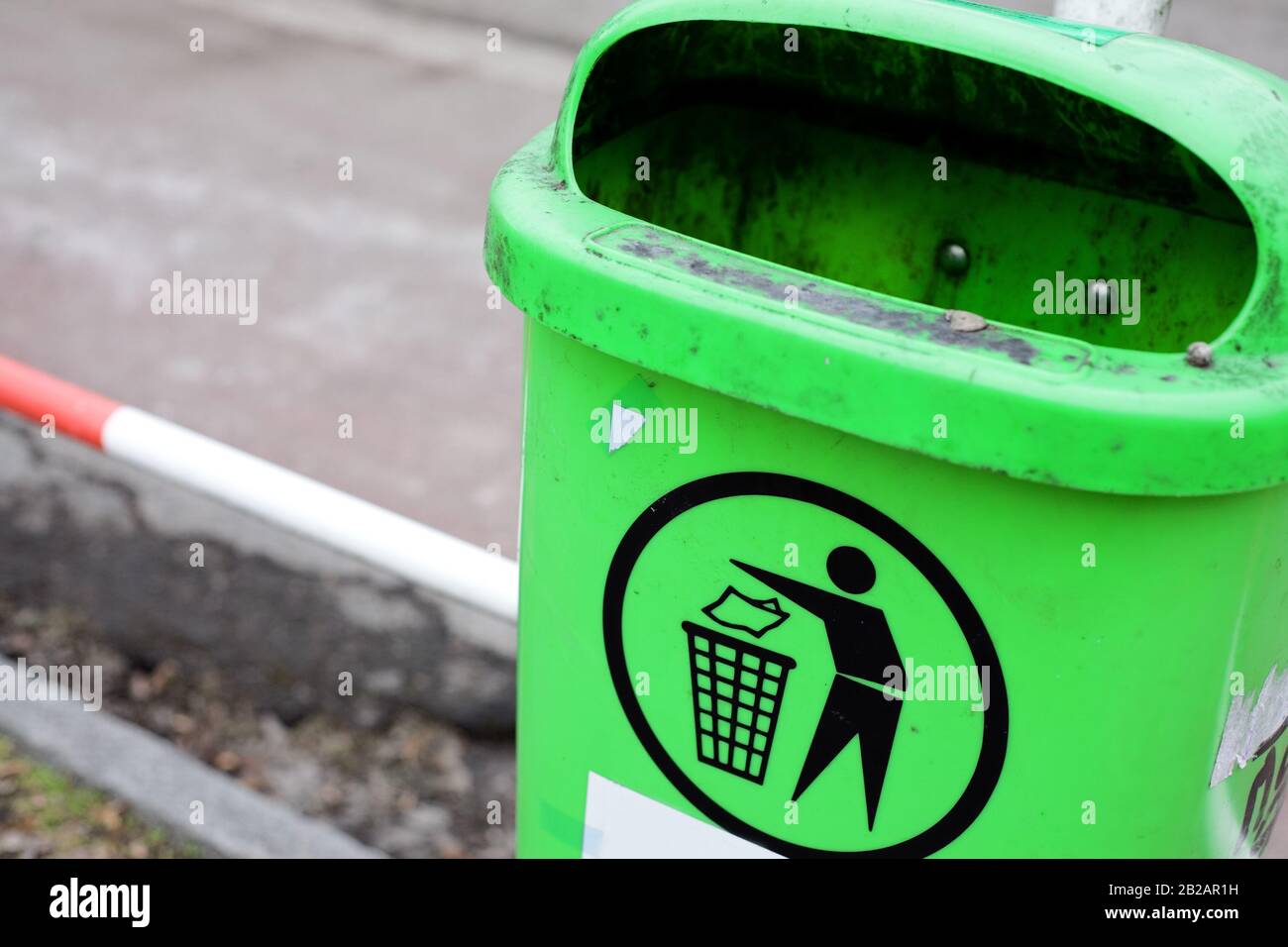 Old dirty garbage bin with pictorial of a man on it Stock Photo - Alamy