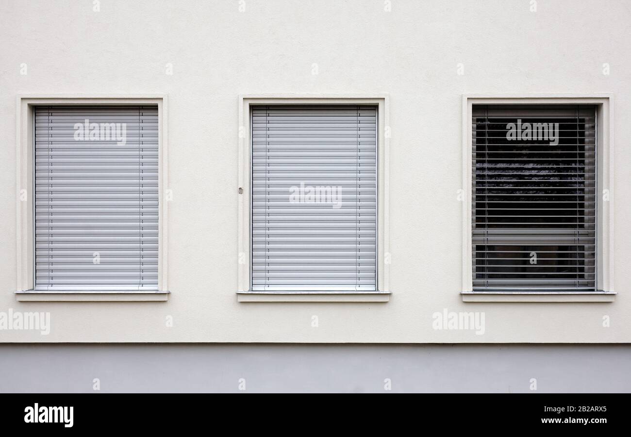 Three windows on a contemporary style building. Two of them have the ...