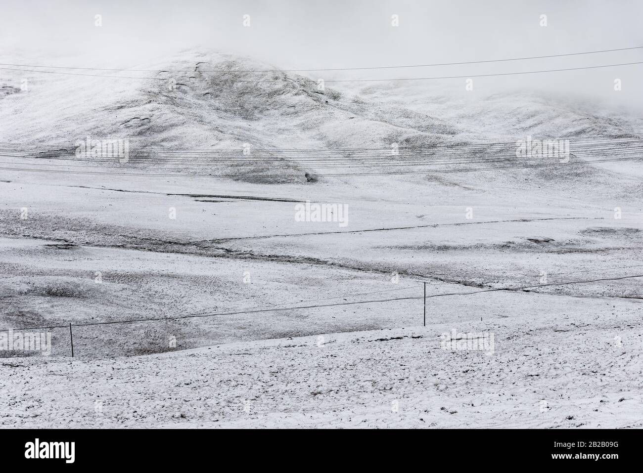 telegraph pole, electric wire and mountain which covered with snow ...