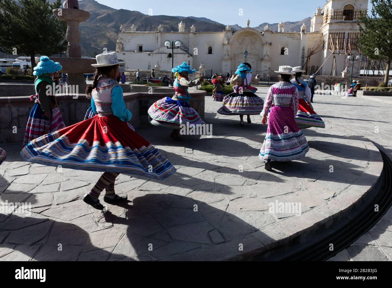 Peruvian girls with typical Andean costumes dancing in the main square ...
