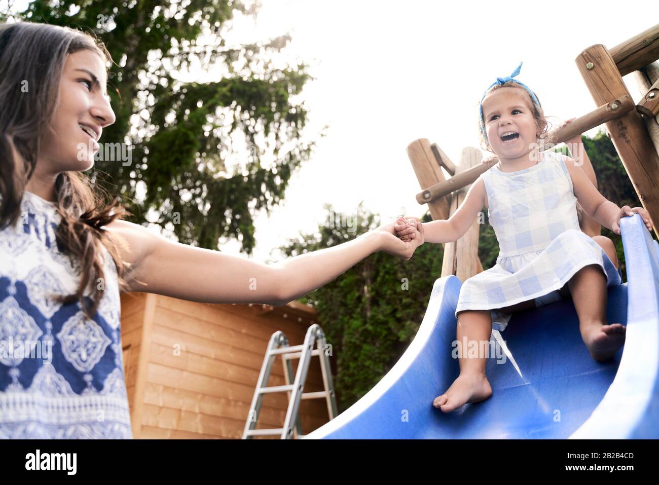 Girl going down slide hi-res stock photography and images - Alamy