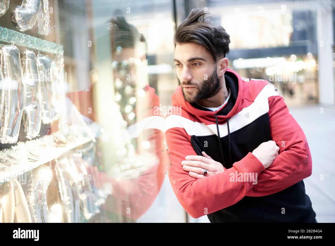 man looking at shop window Stock Photo - Alamy