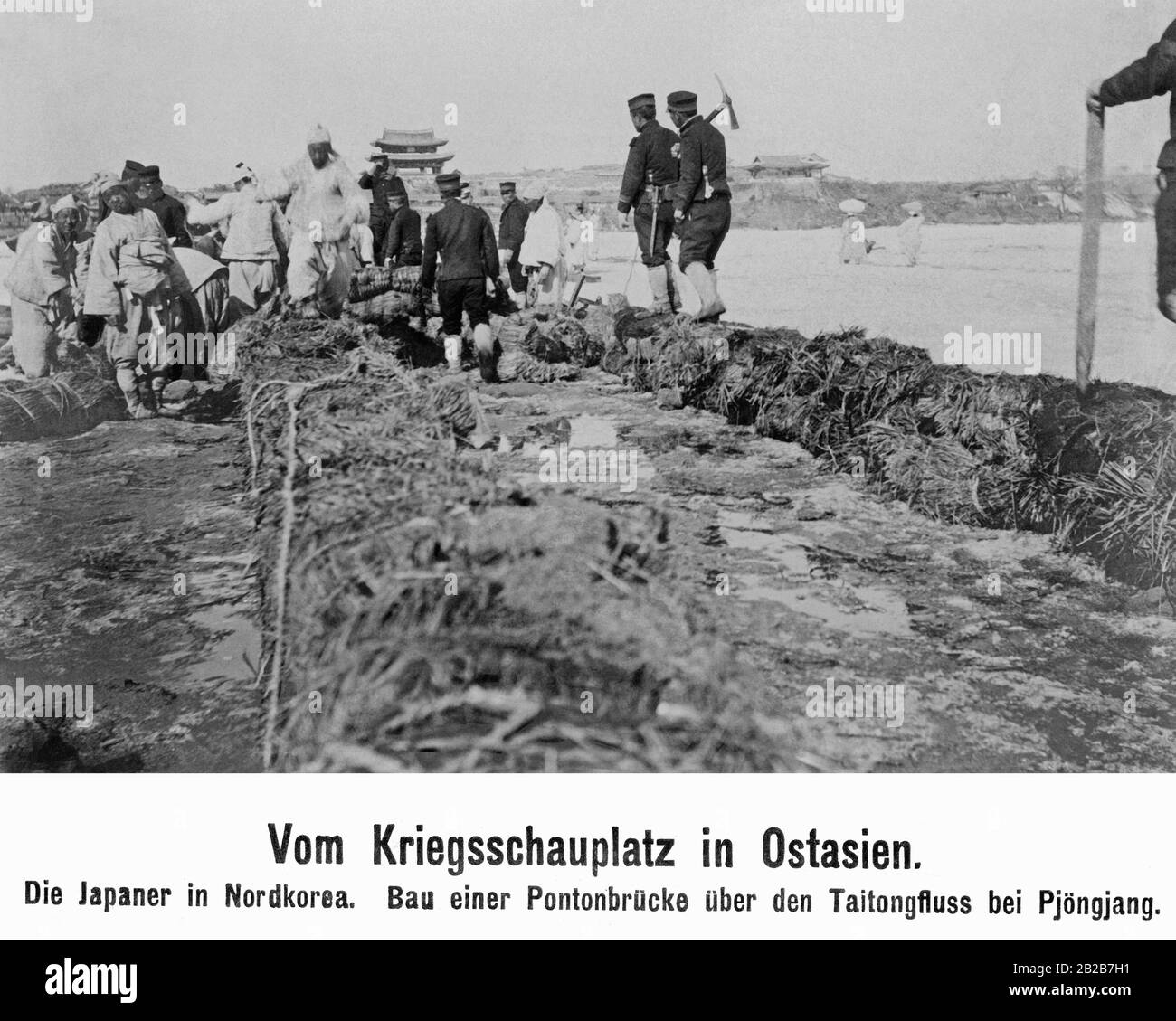 Japanese soldiers and construction workers building a bridge over the ...