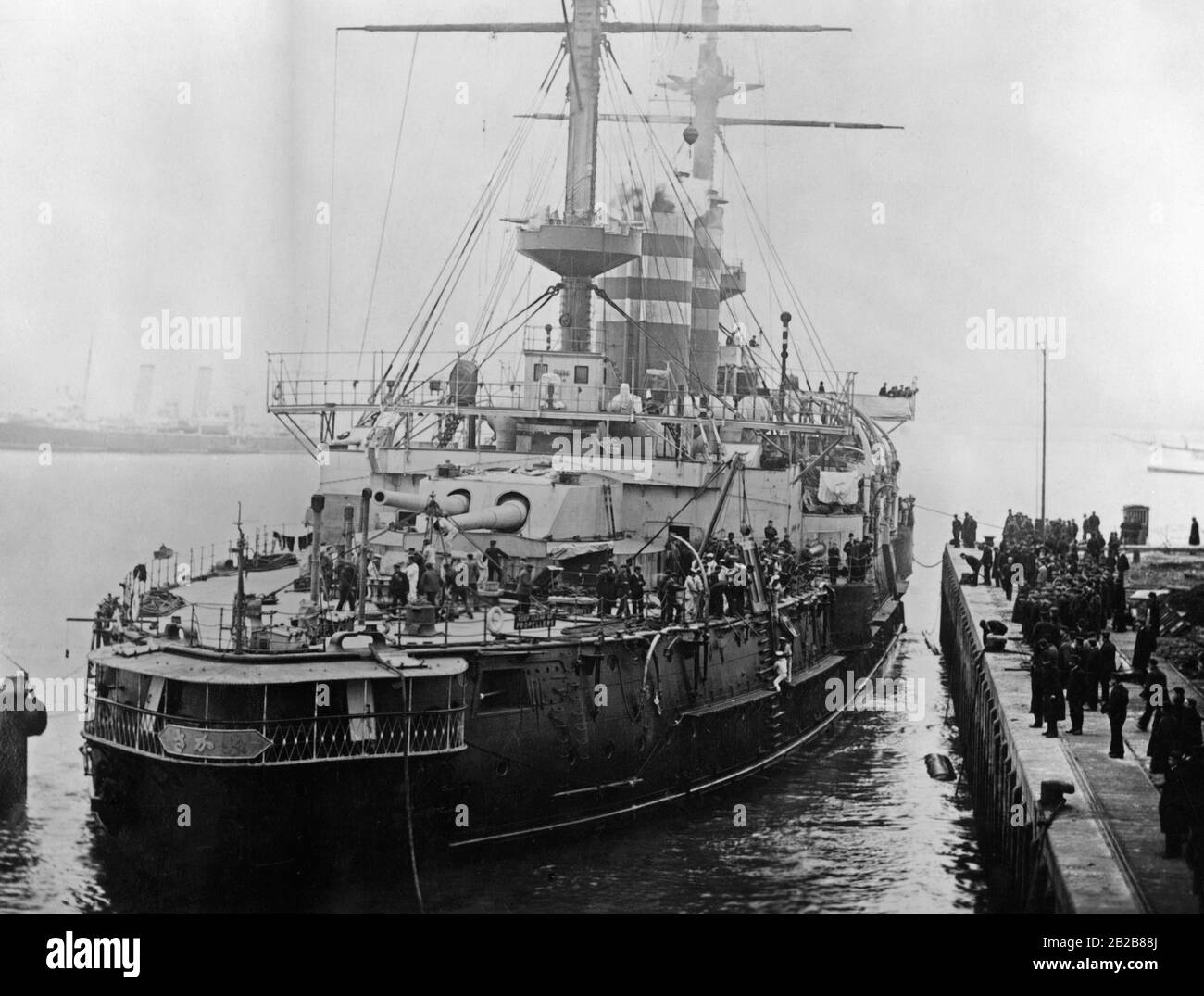 The Japanese armoured ship Mikasa sets sail from a port. (Undated photo ...