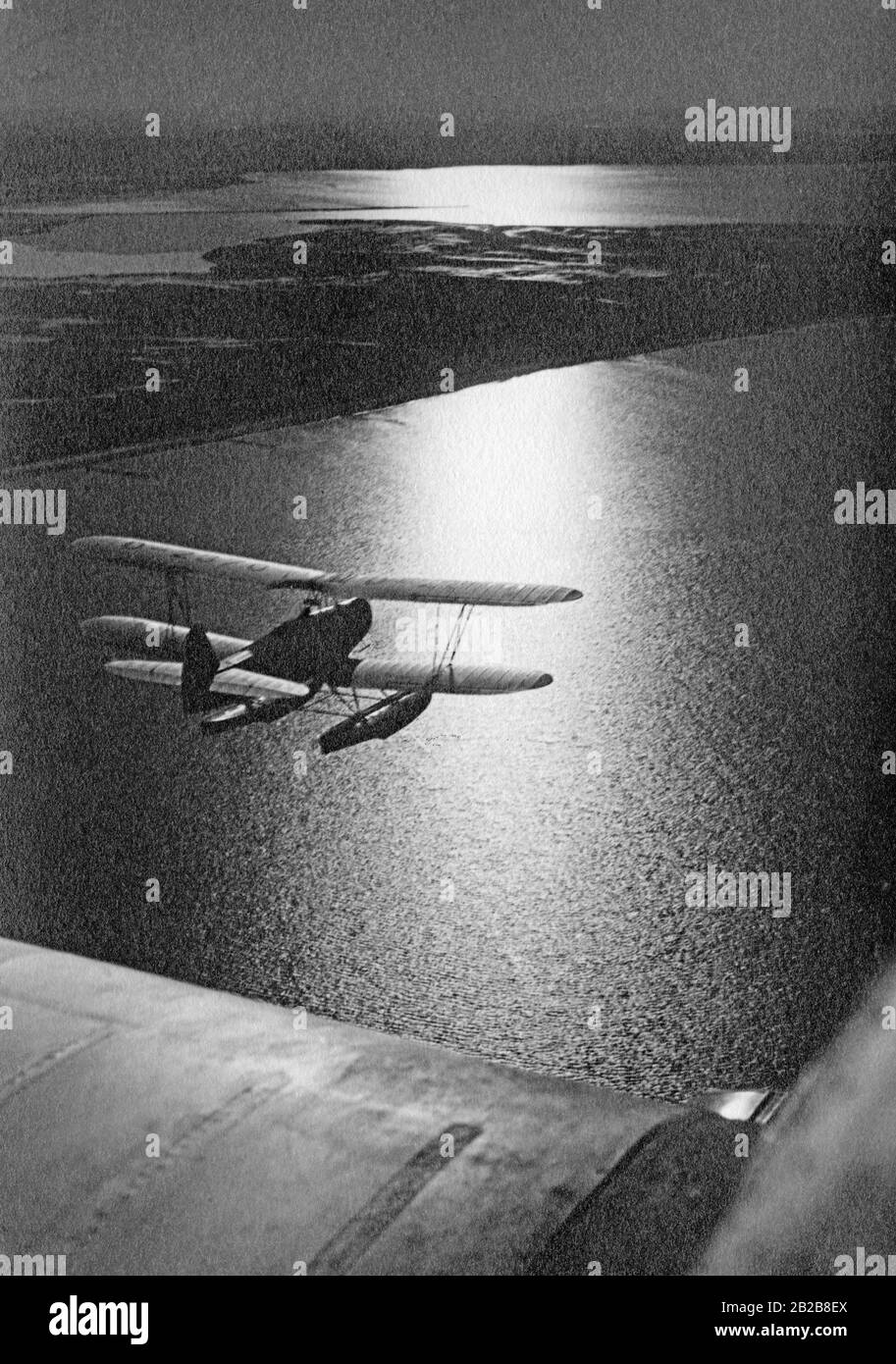 A biplane with floats before landing on the water Stock Photo - Alamy