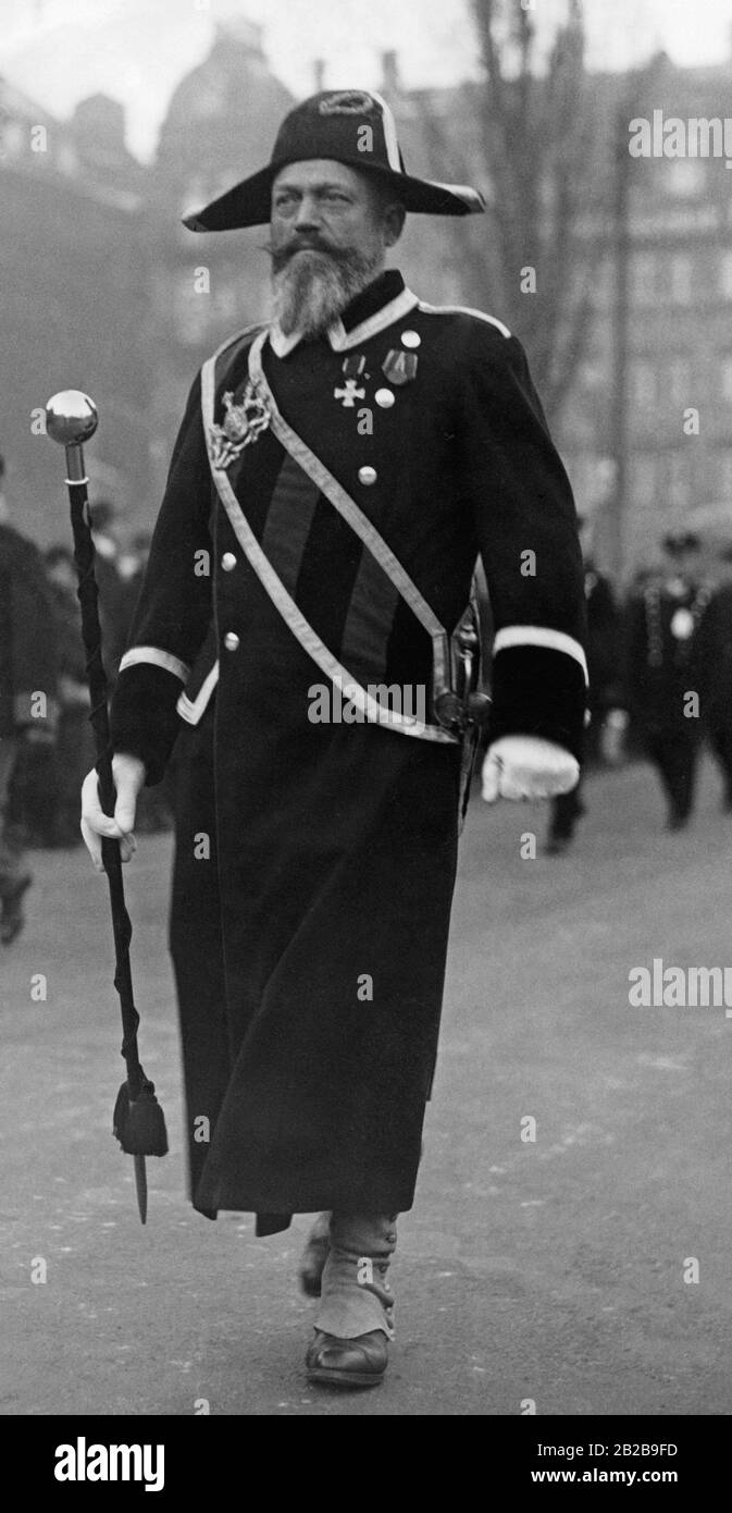 A railway employee in the historic uniform of a railway station porter ...