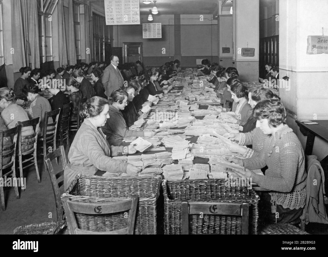 Women sort the incoming giro payment cards by account number. Undated ...