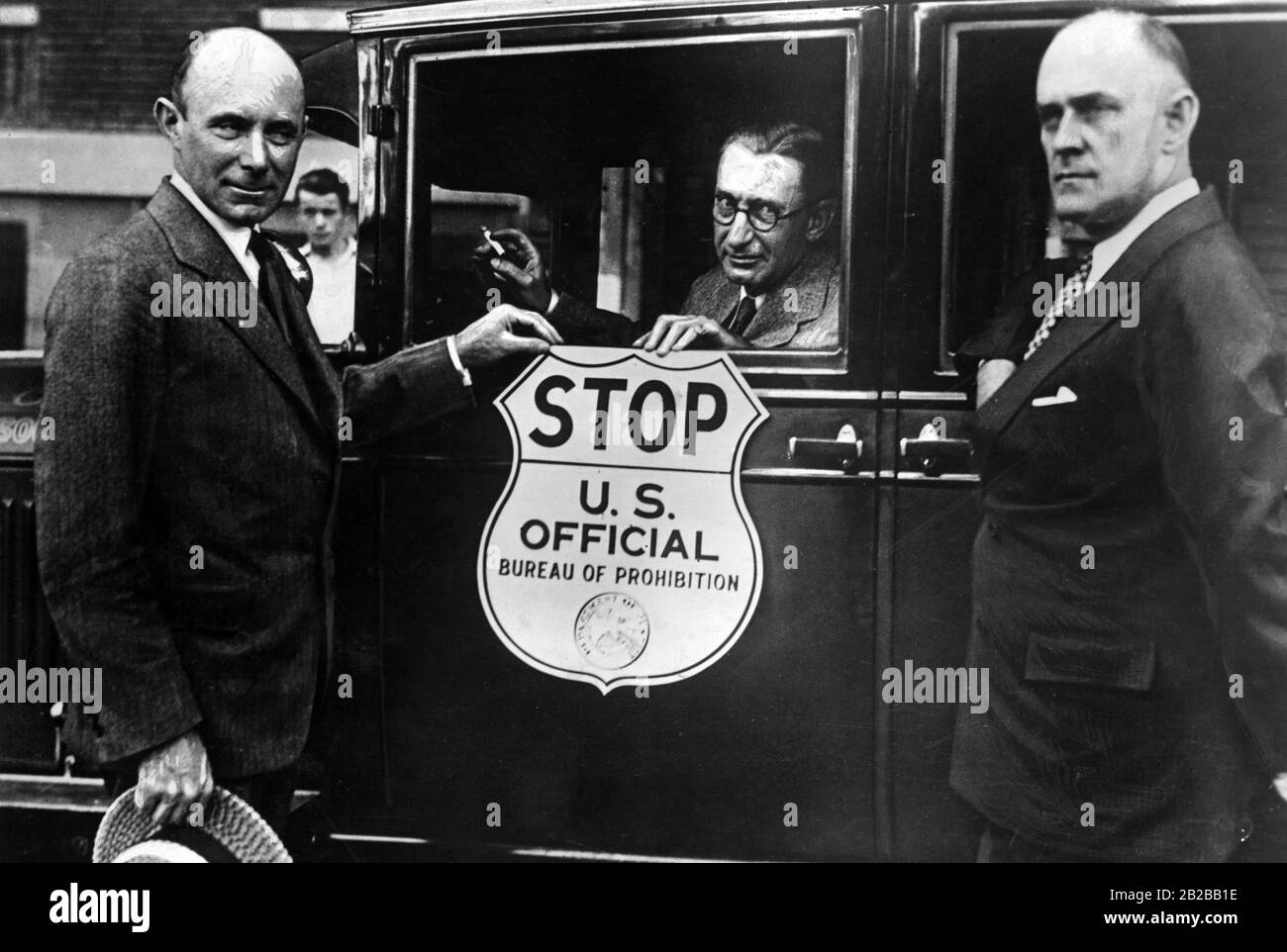 Prohibition: Policemen show a car, that is disguised as an unmarked car ...