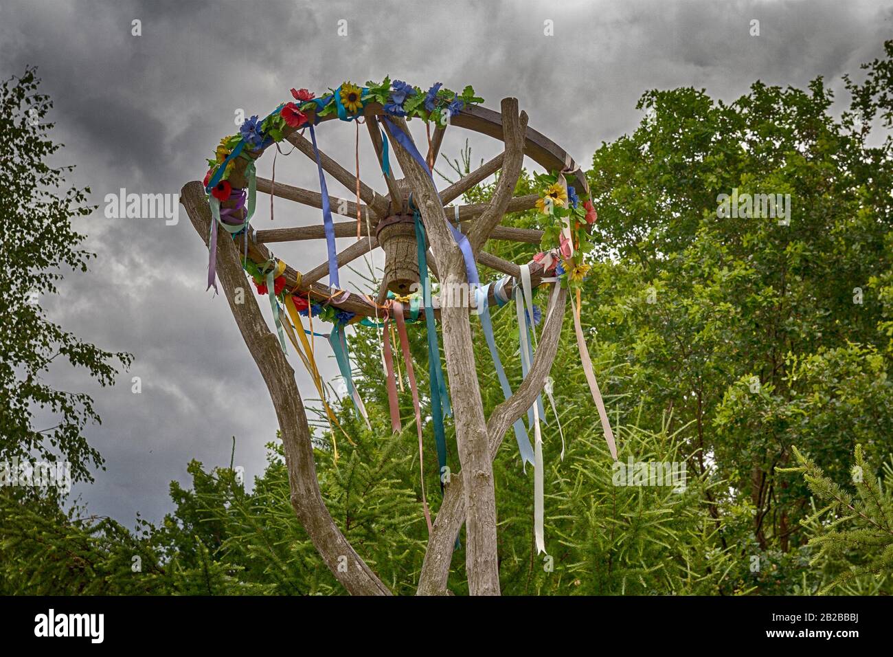 Wooden wheel with bright ribbons. Slavic celebration of Midsummer Stock ...