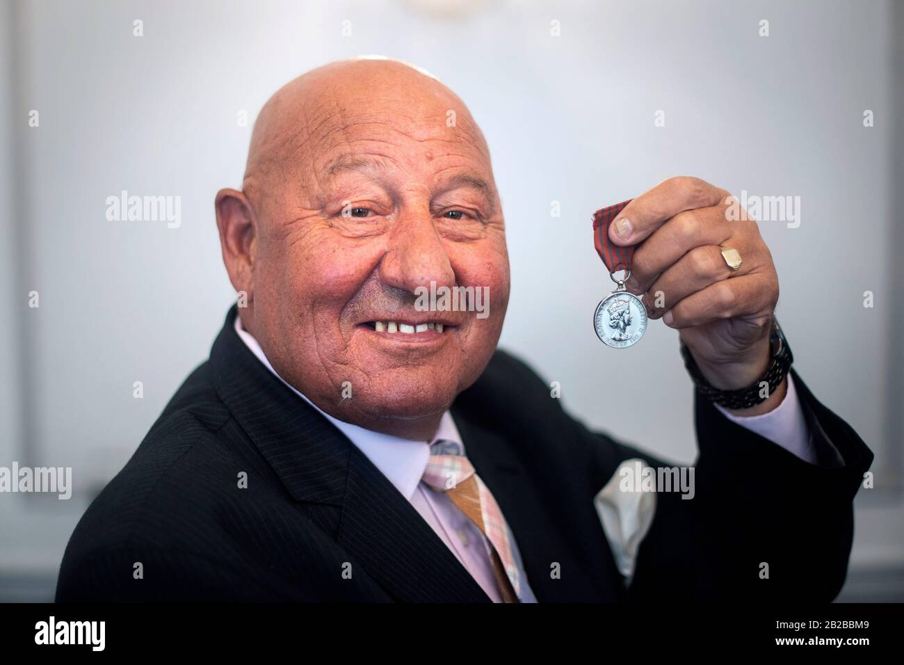 Former heavyweight boxer Ronnie Russell poses with the George Medal he ...