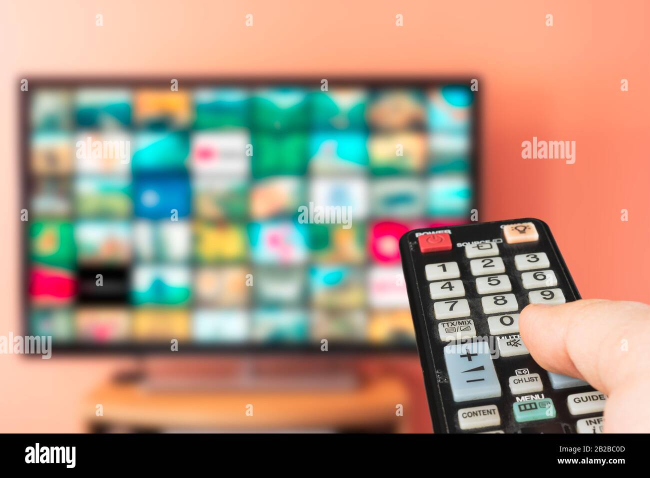 Caucasian man choosing what to watch on TV at home. Video on demand or ...