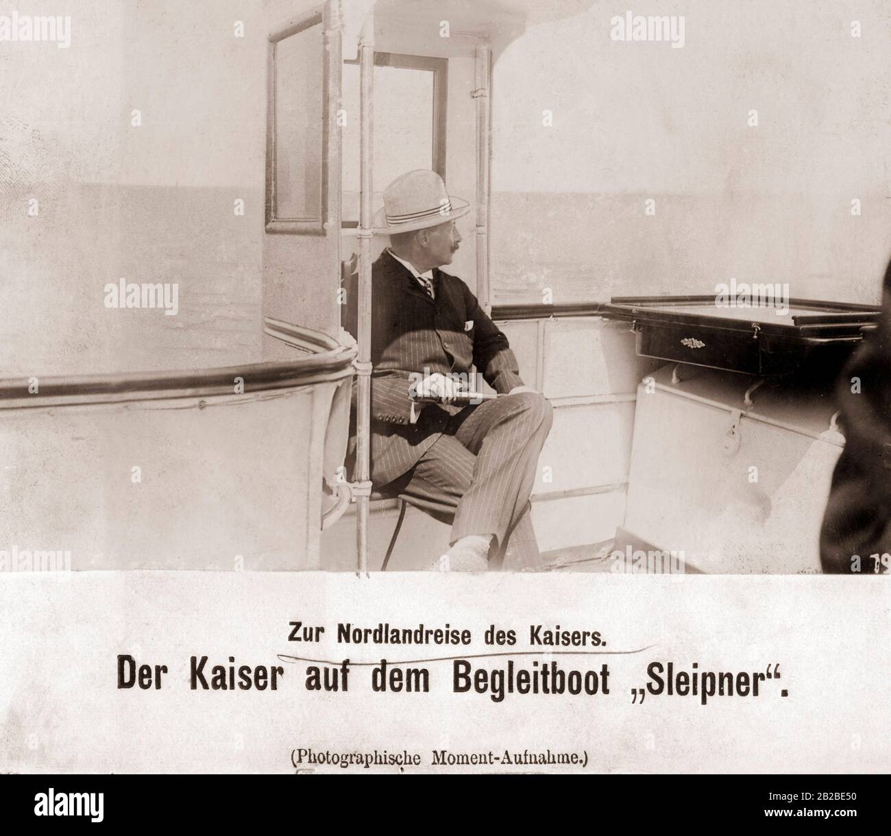 Emperor Wilhelm II sits in civilian clothes on the deck of the tender ...