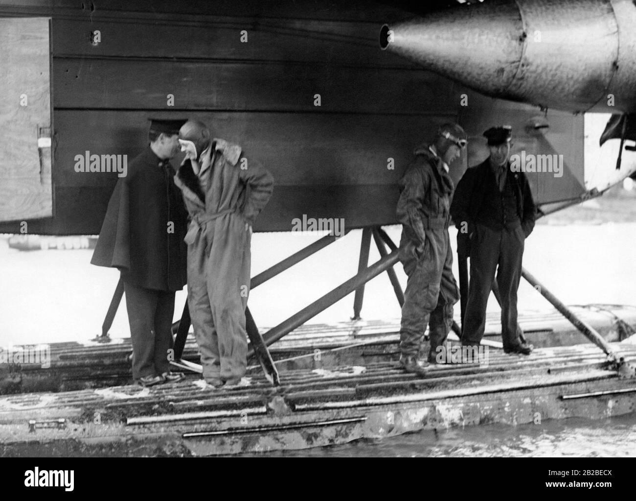 Amelia Earhart with her pilot and mechanic on the floats of the "Friendship" after her first ...