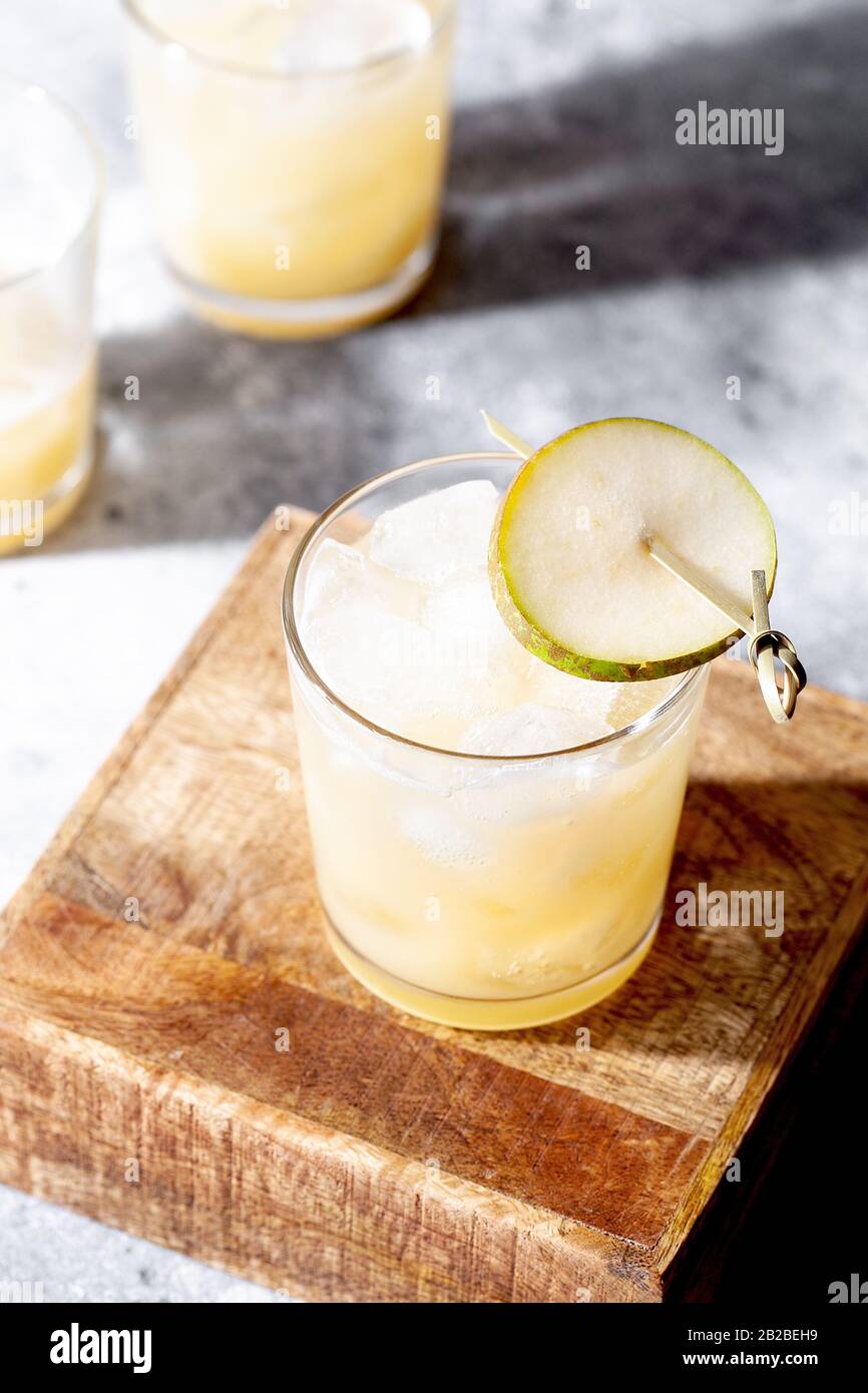 Cold pear cocktail or mocktail with soda and pear puree and fruit ...