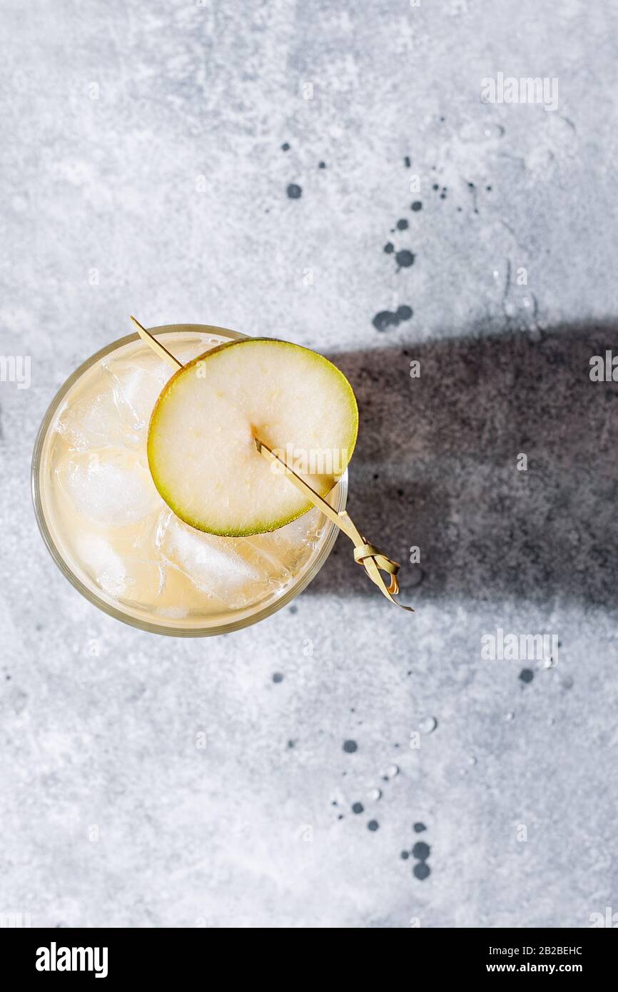 Cold pear cocktail or mocktail with soda and pear puree and fruit ...