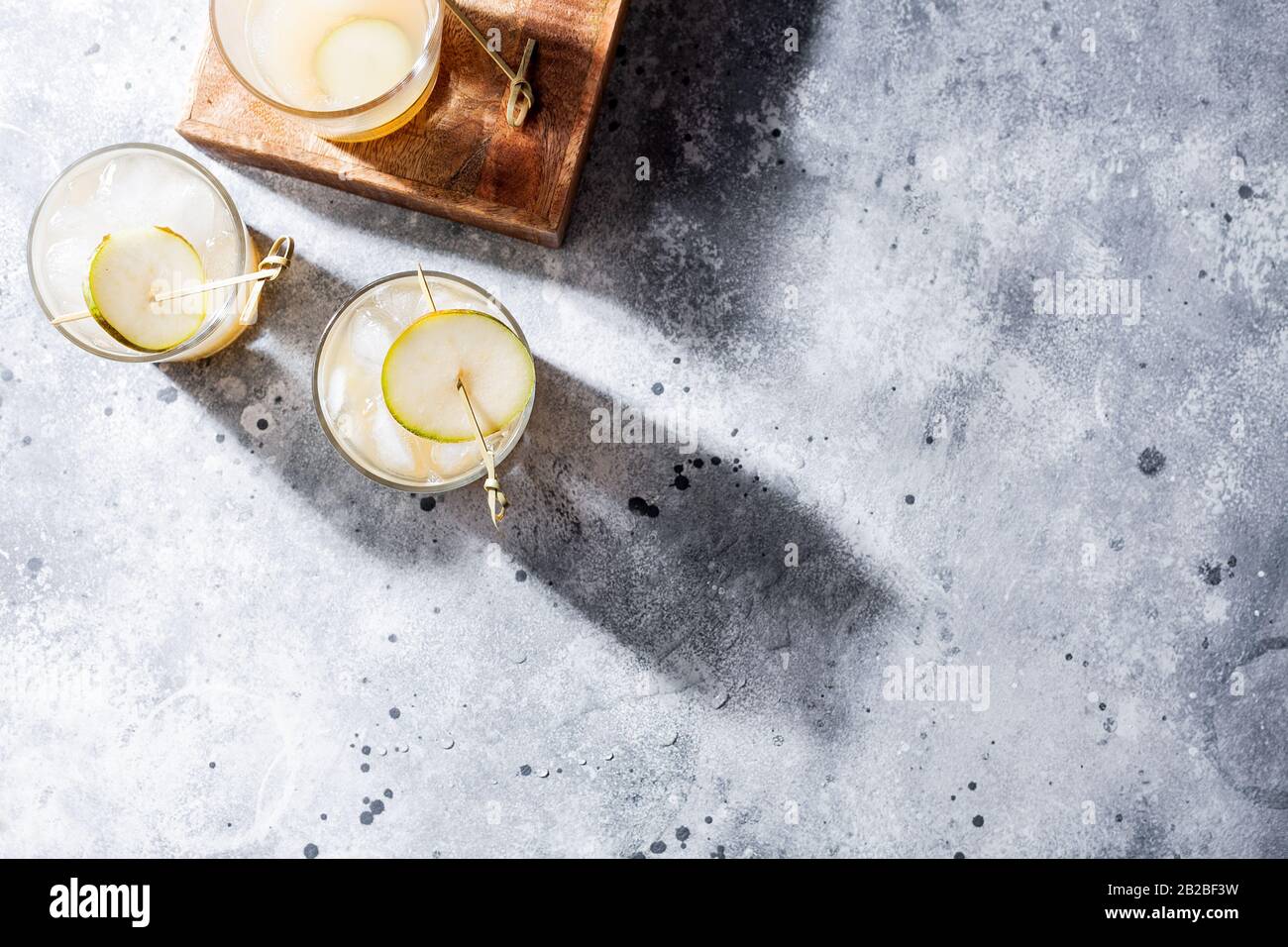 Cold pear cocktail mocktail with soda and pear puree and fruit slices ...