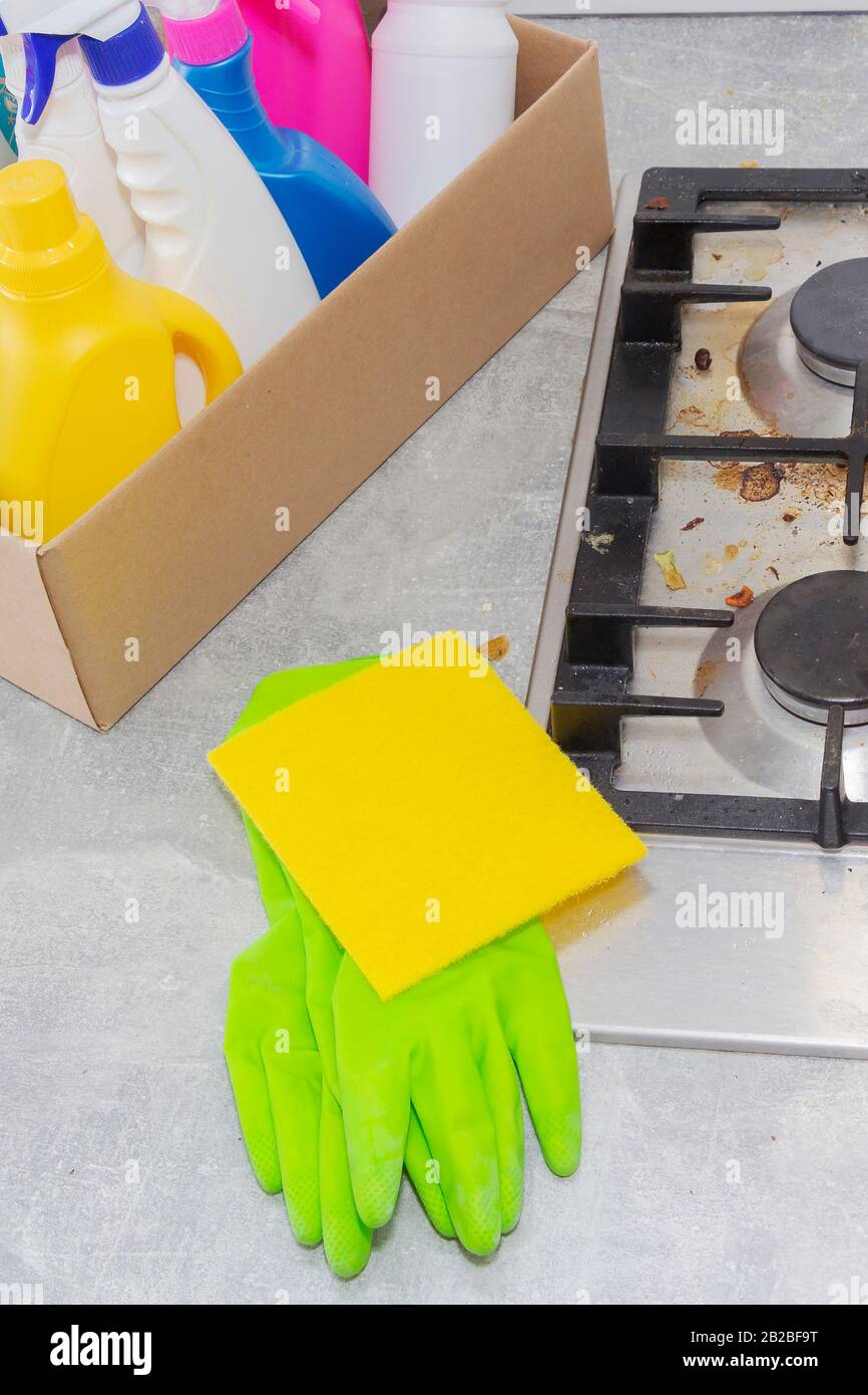 Cleaning a gas stove with kitchen utensils, household concepts, or ...