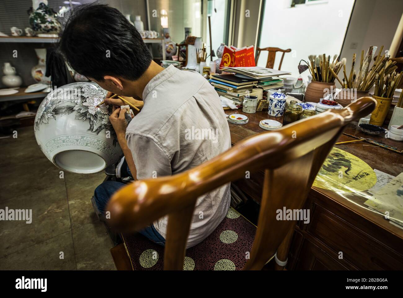 BEIJING, СHINA - JUNE 03: Chinese craftsman paints a large porcelain ...