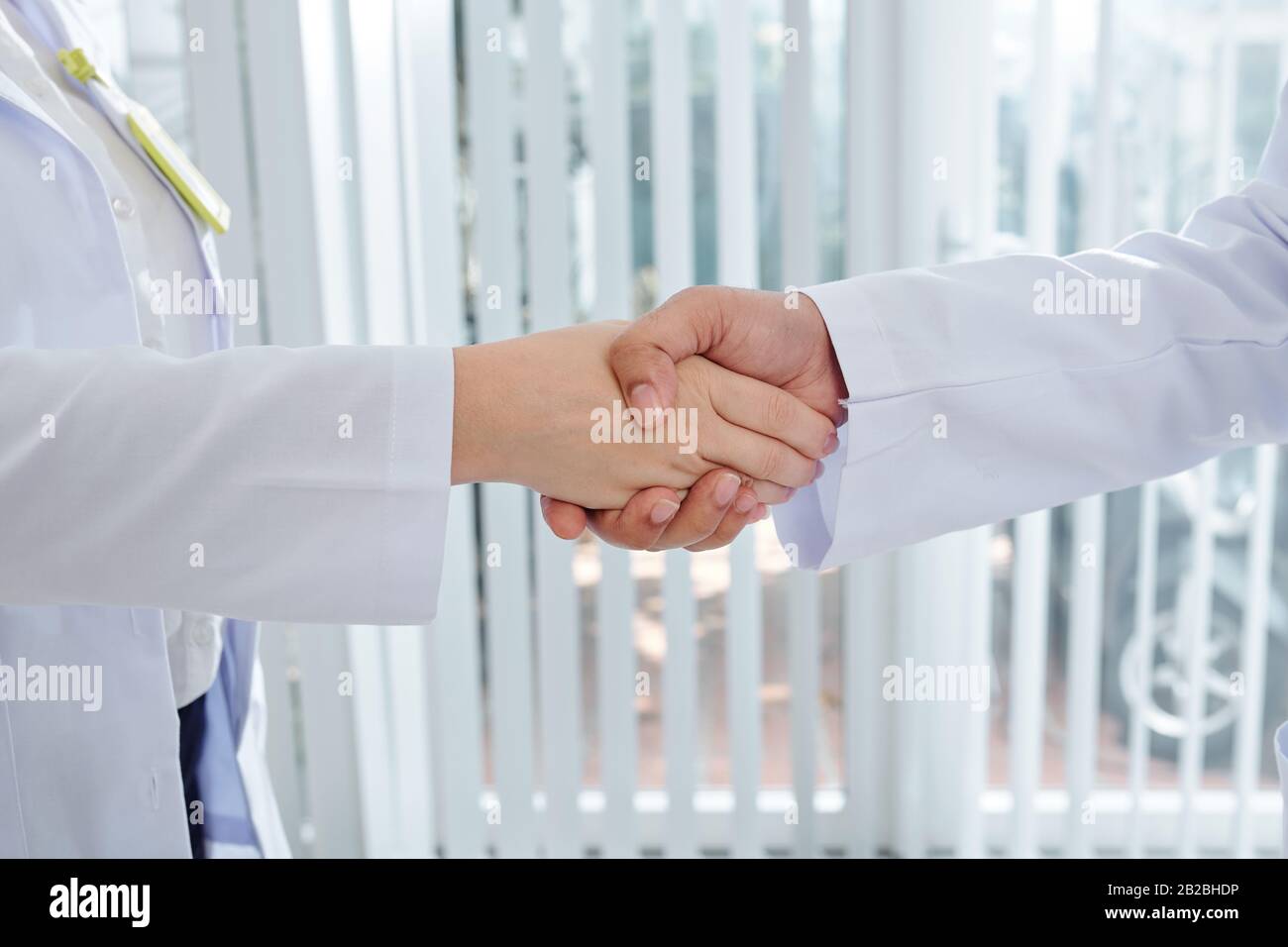 Close-up image of medical workers shaking hands when meeting in ...