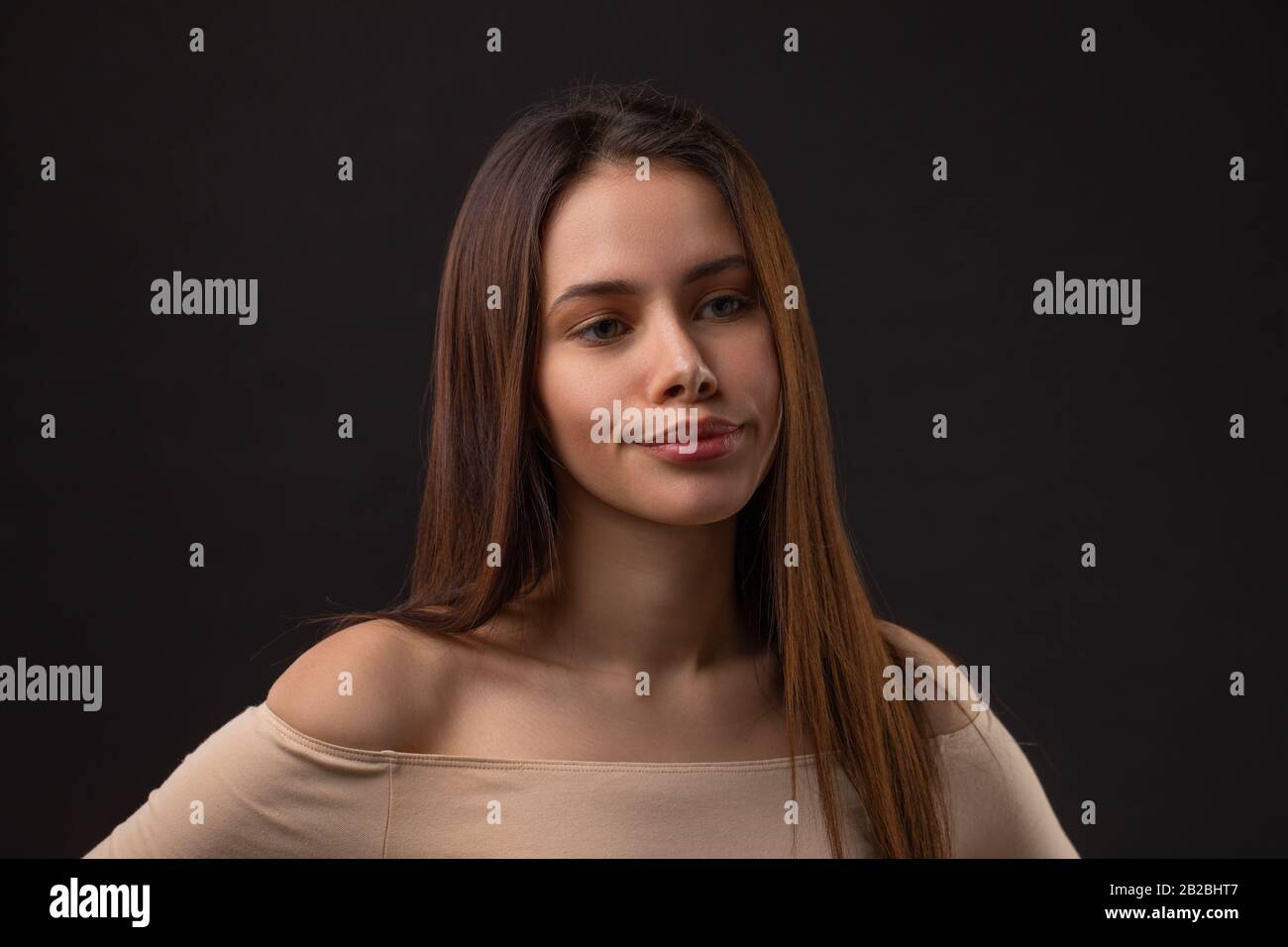 Sarcasm emotion Brunette girl portrait against black background Stock ...