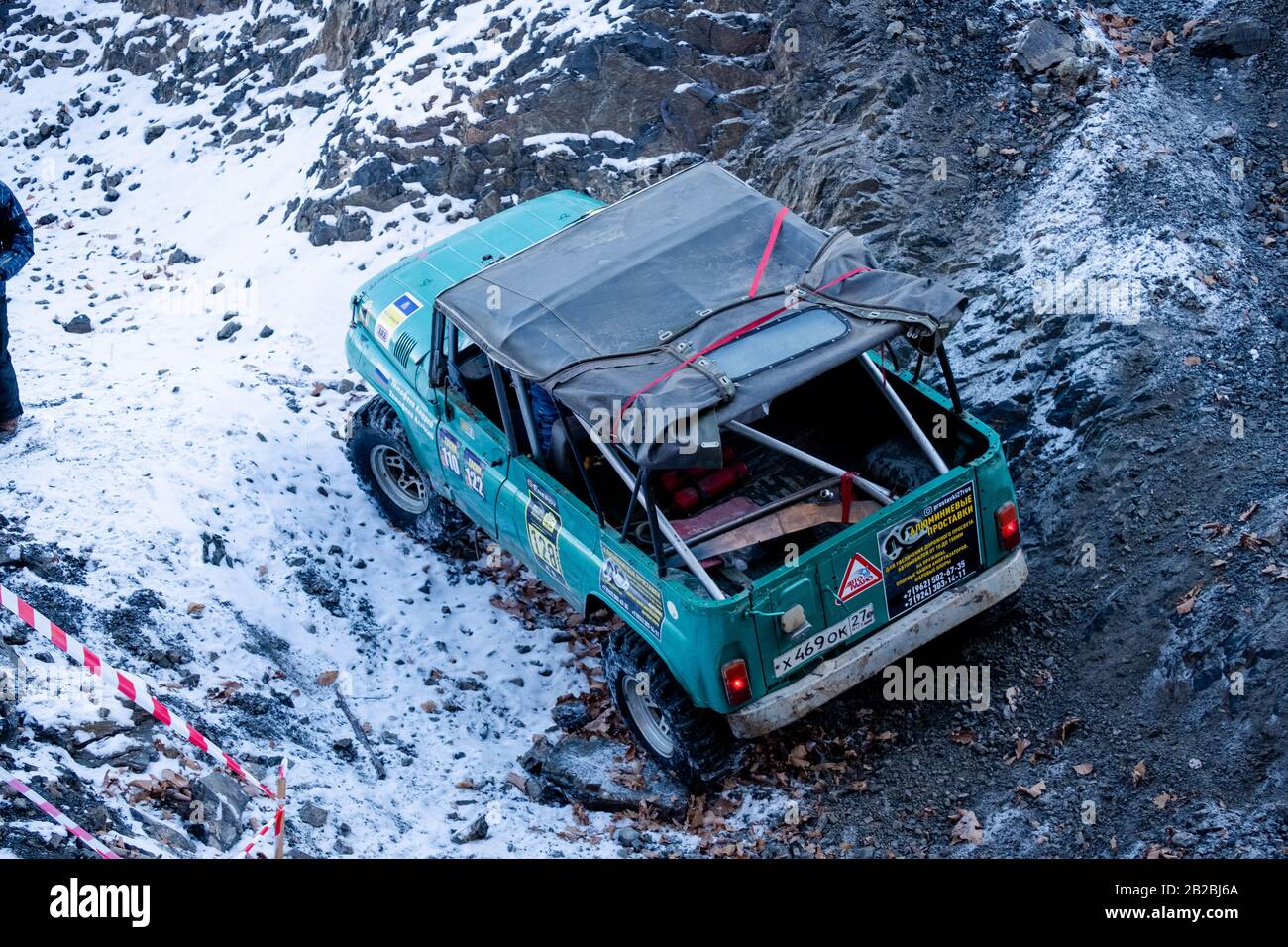 Jeep Suzuki Jimny overcomes obstacles in the forest Stock Photo - Alamy