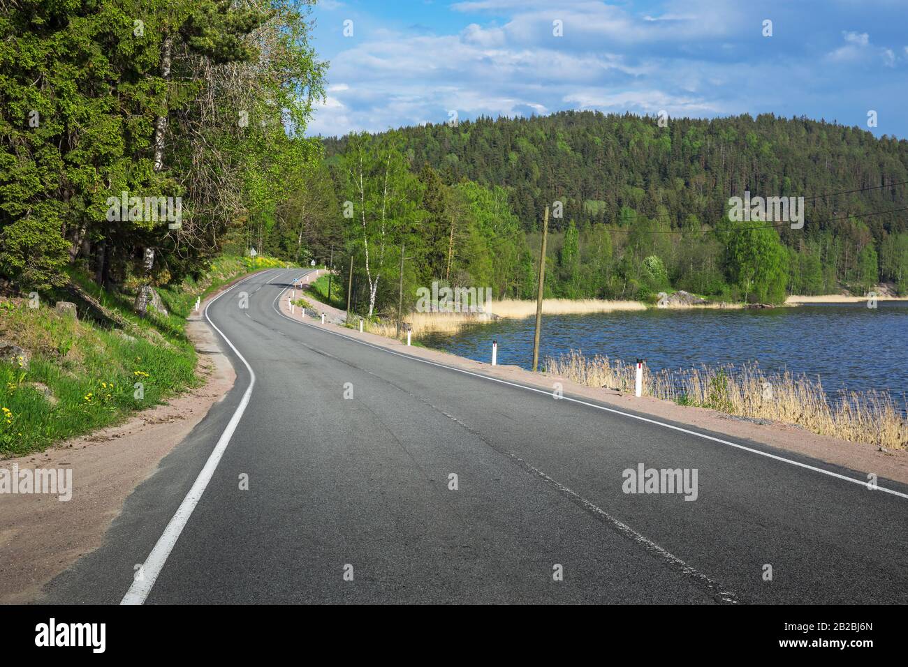 A winding highway along the lake Stock Photo - Alamy