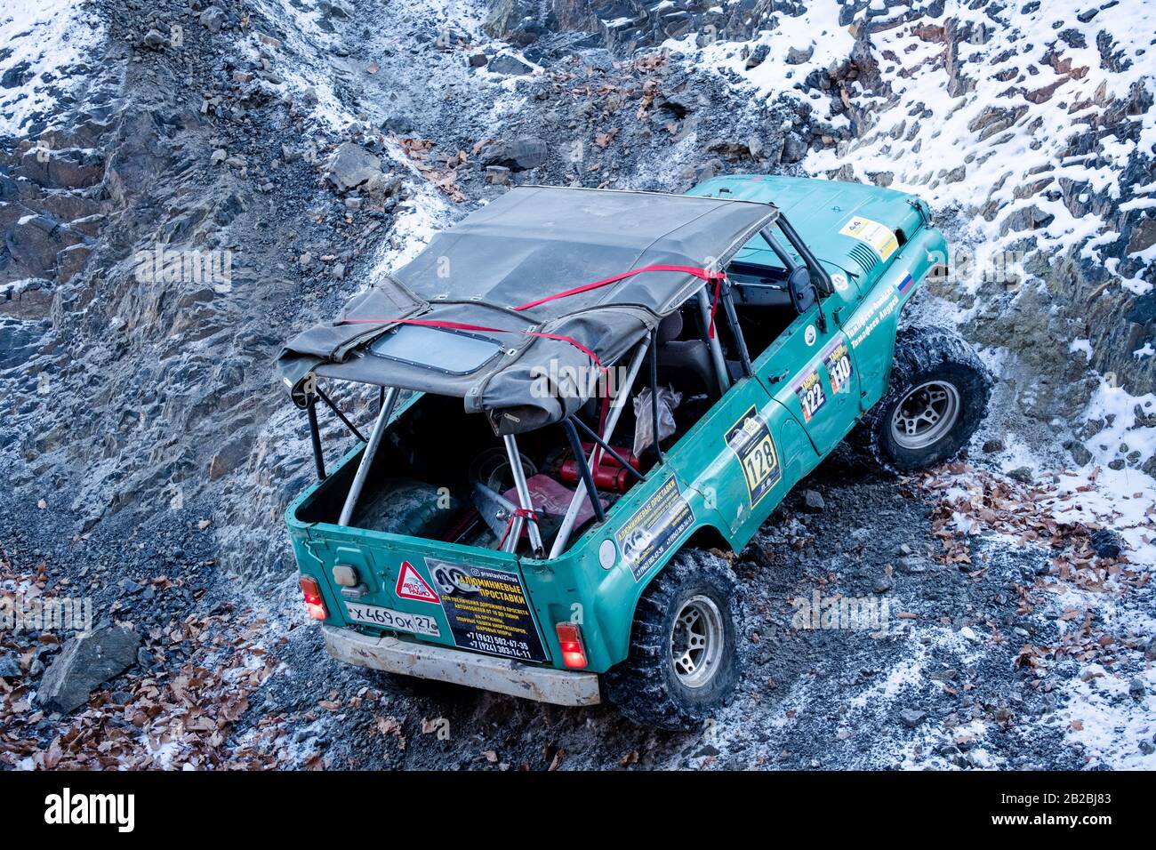 Jeep Suzuki Jimny overcomes obstacles in the forest Stock Photo - Alamy