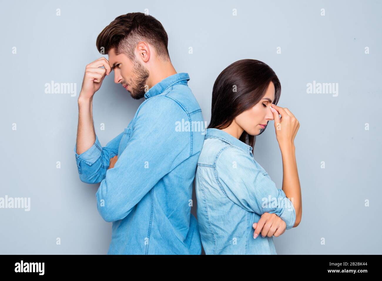 Two sad lovers standing back to back after quarrel Stock Photo - Alamy