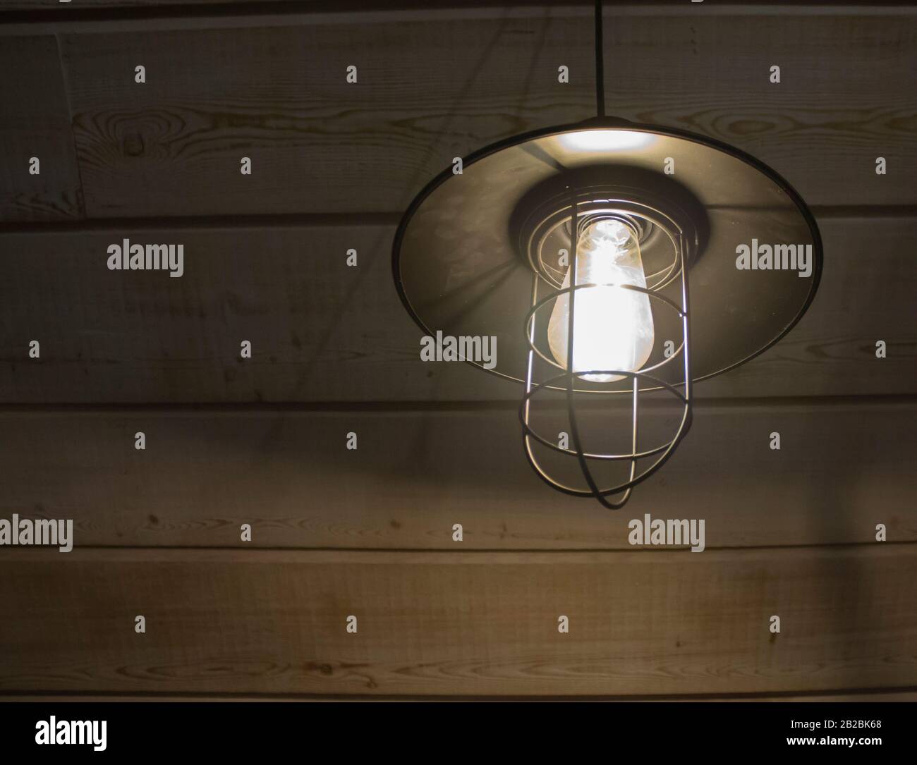 Old fashioned vintage lantern lamp burning with a soft glow light in an ...