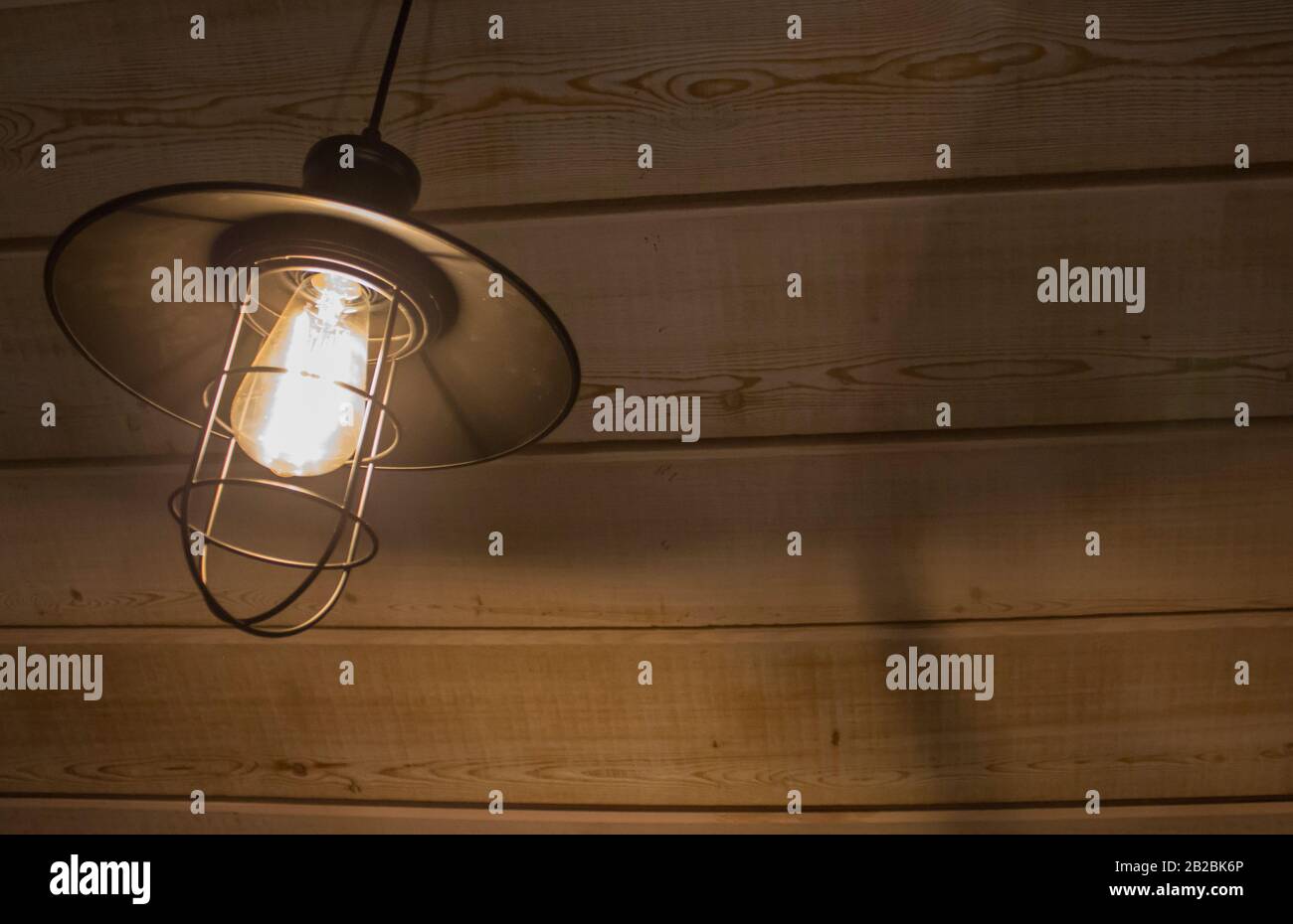 Old fashioned vintage lantern lamp burning with a soft glow light in an ...