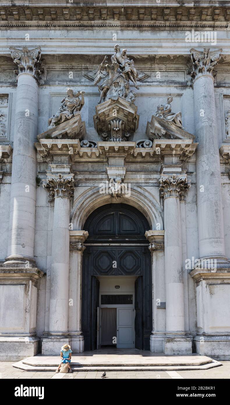 Tourist on the steps at the entrance to the Church of San Stae in ...