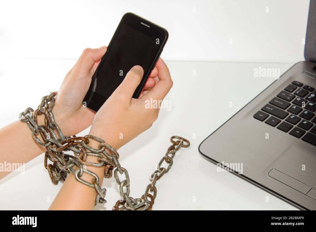 Iron chain ties together hands and smartphone - mobile phone addiction ...