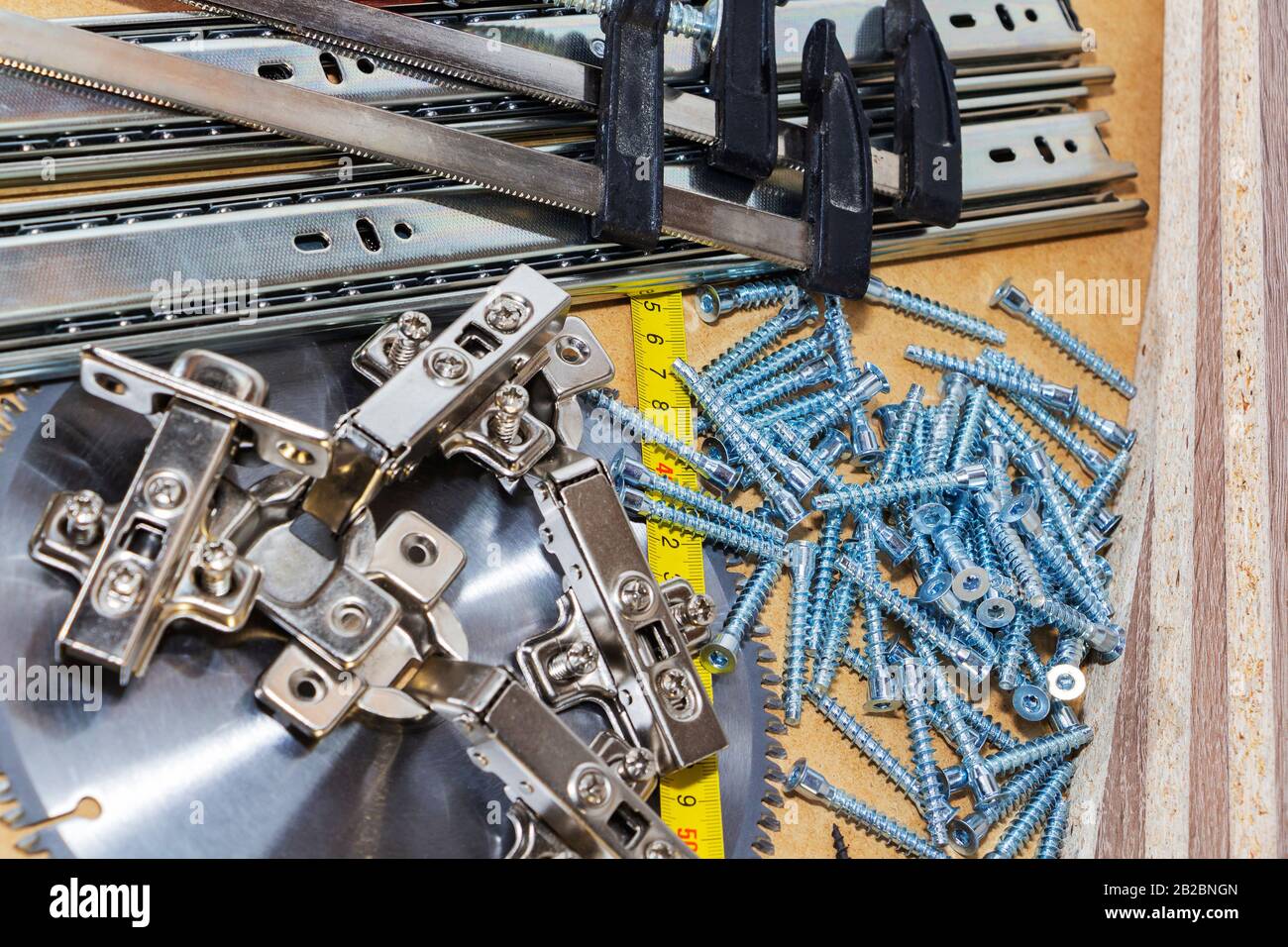 Screws, confirmations for furniture, tape measure, clamp, lie on the ...
