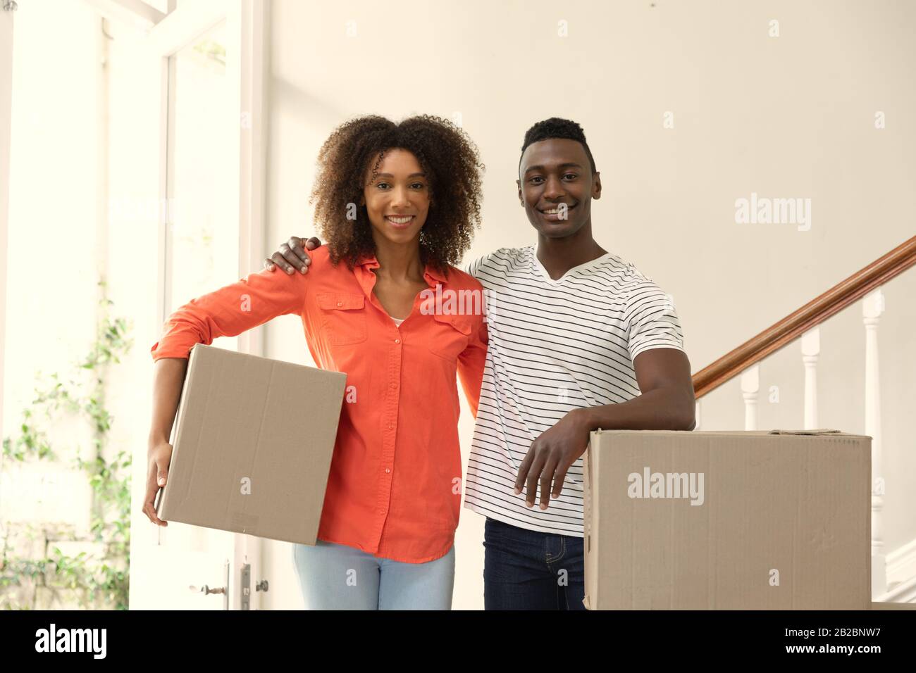 Couple moving in to a new home Stock Photo - Alamy