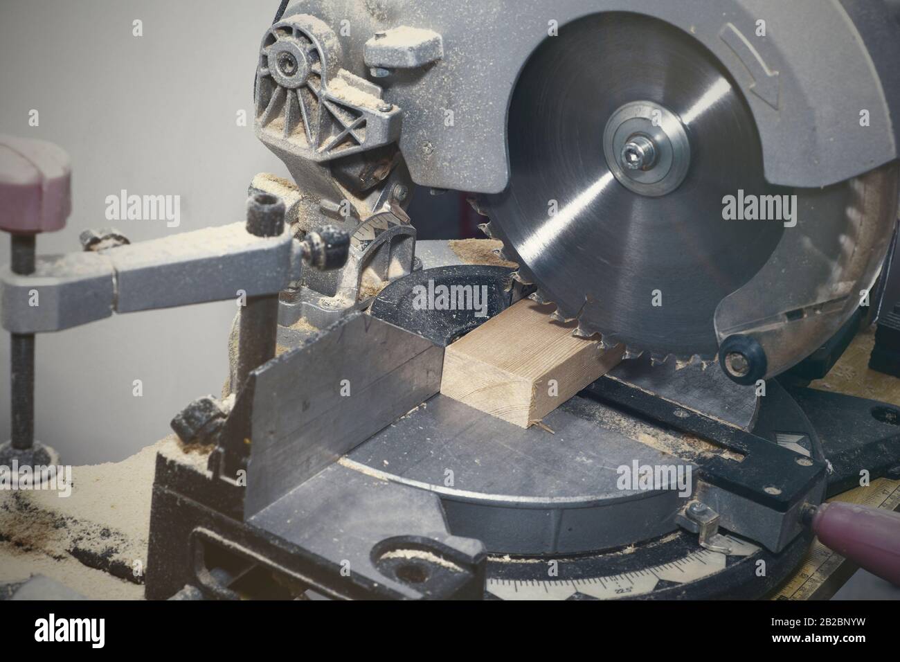 A miter saw making a compound cut through construction lumber Stock ...