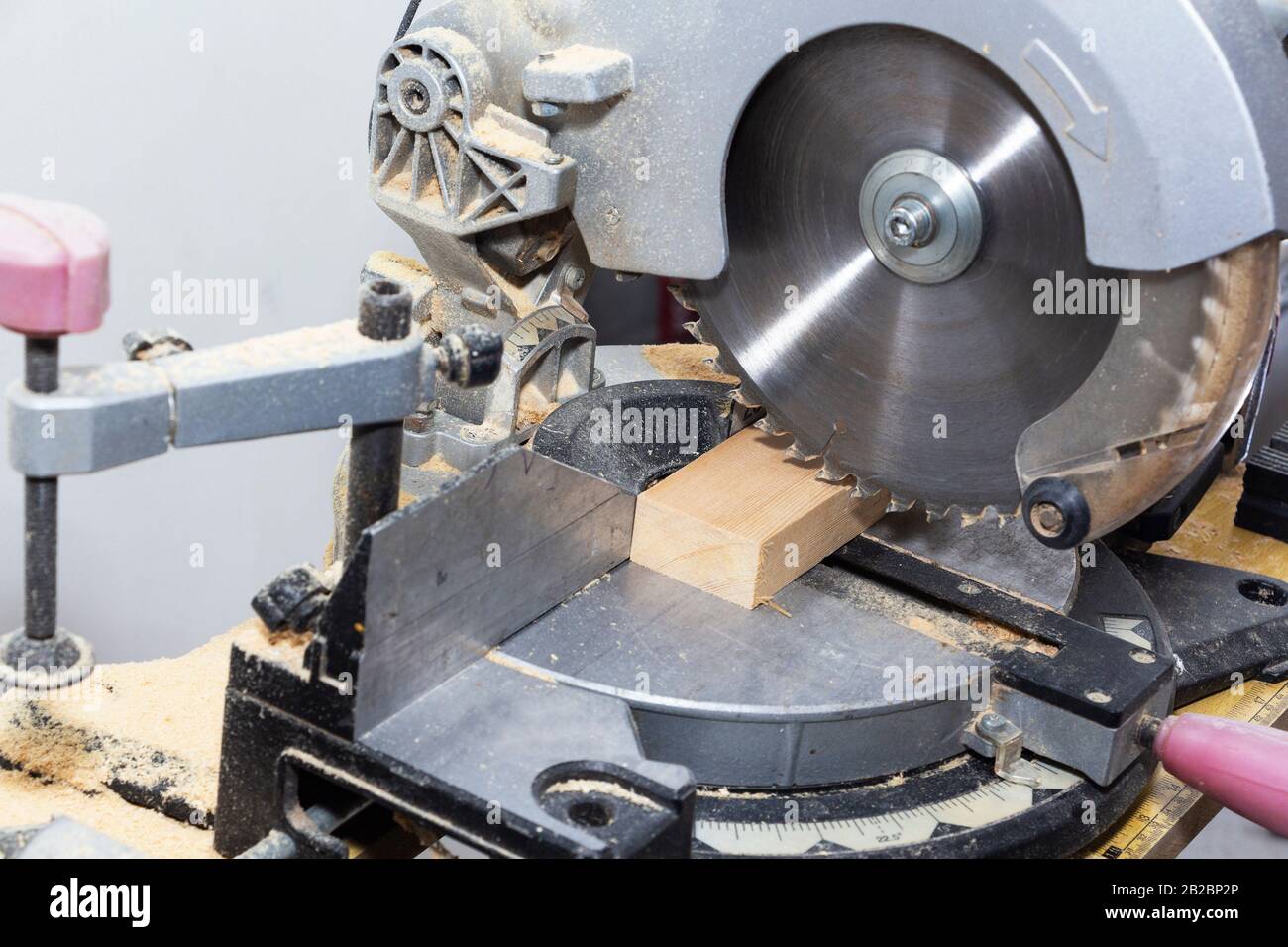 A miter saw making a compound cut through construction lumber Stock ...