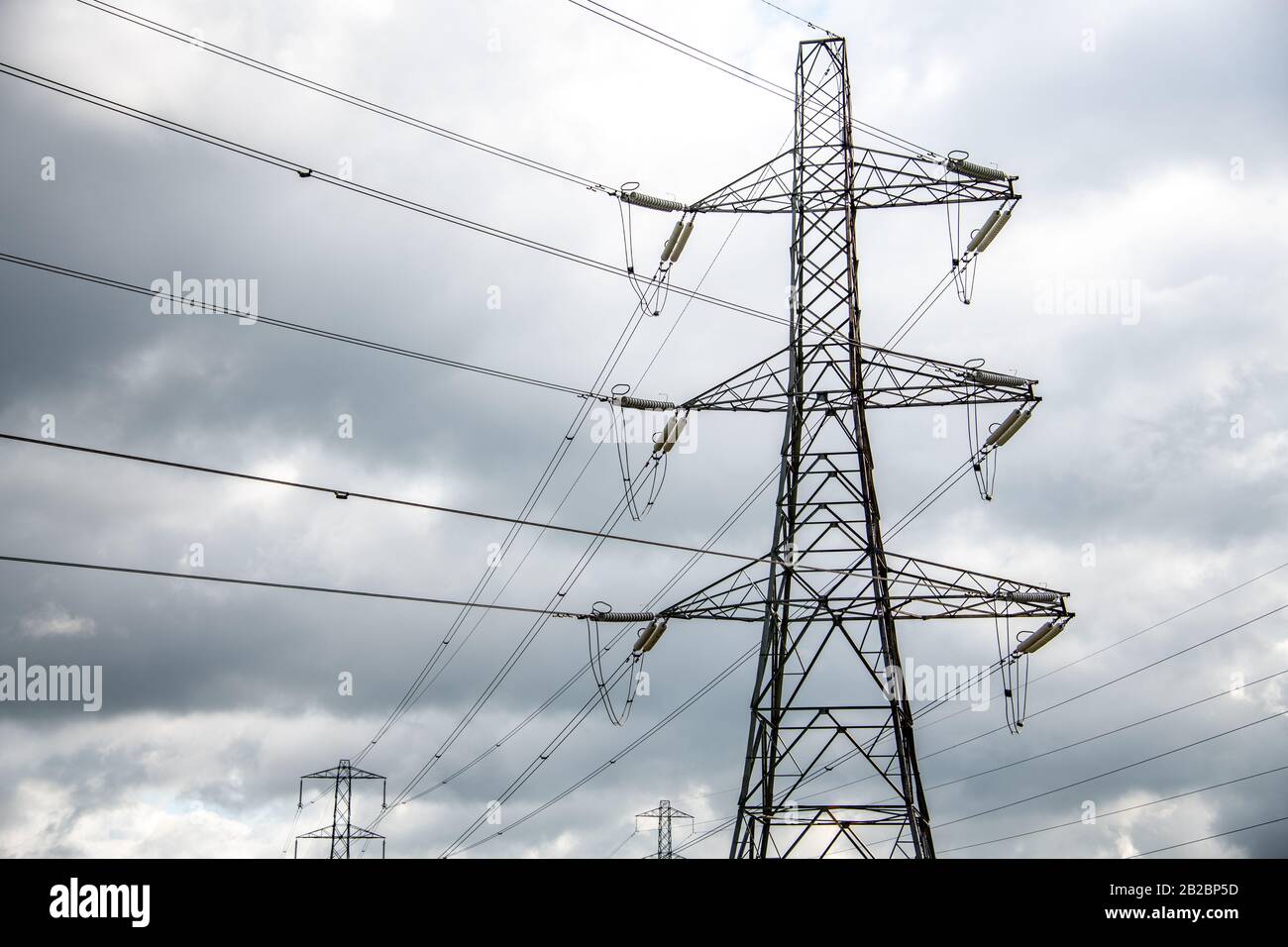 High voltage electricity pylons and power lines background. Industry ...