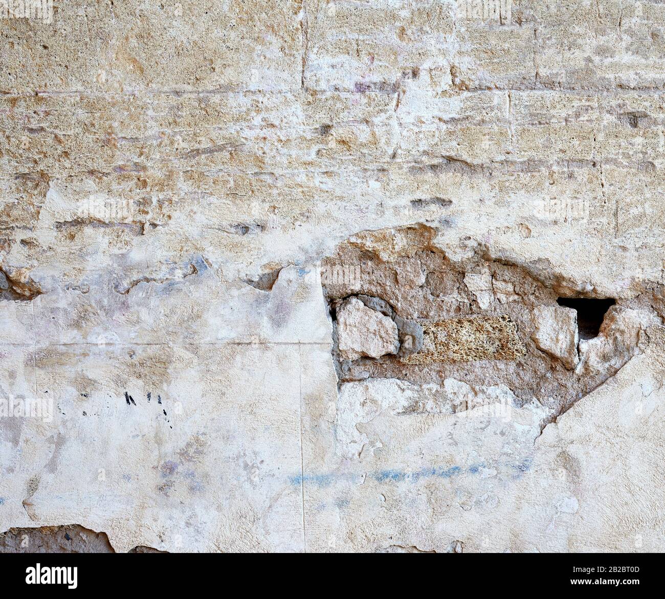 wall of yellow rectangular stones with cement, fragment of ancient ...