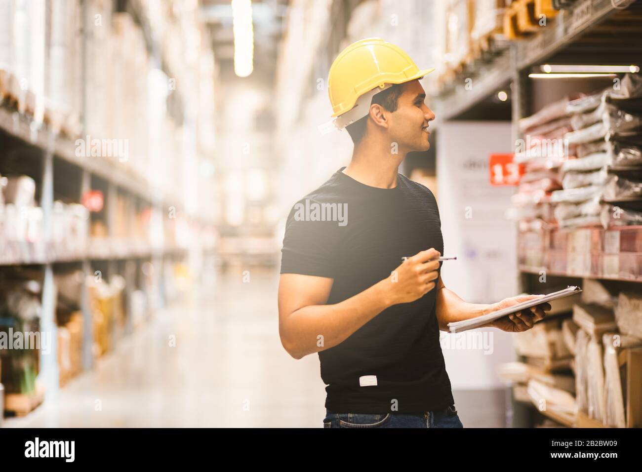 Smart Indian engineer man worker doing stocktaking of product ...