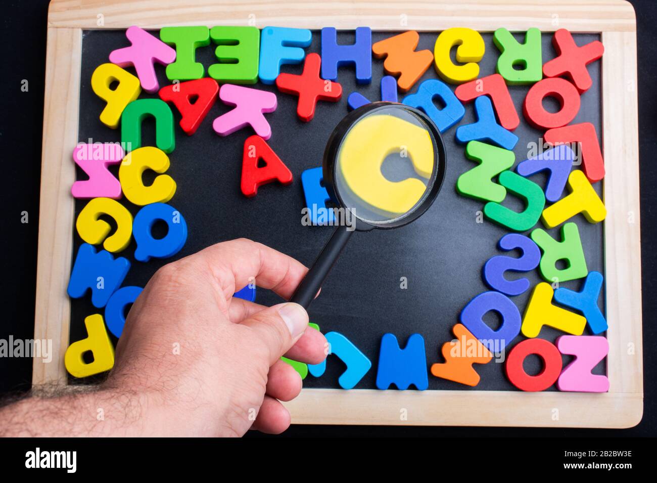 Magnifying glass and Colorful Letters of Alphabet Stock Photo - Alamy