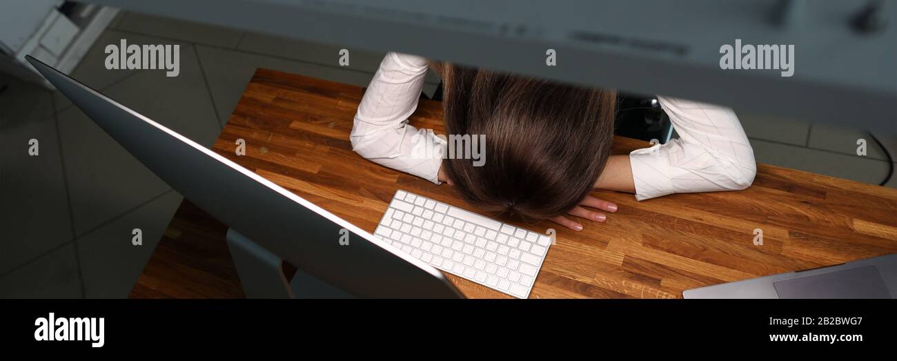 Girl leaned over table office, sleeps with fatigue Stock Photo - Alamy