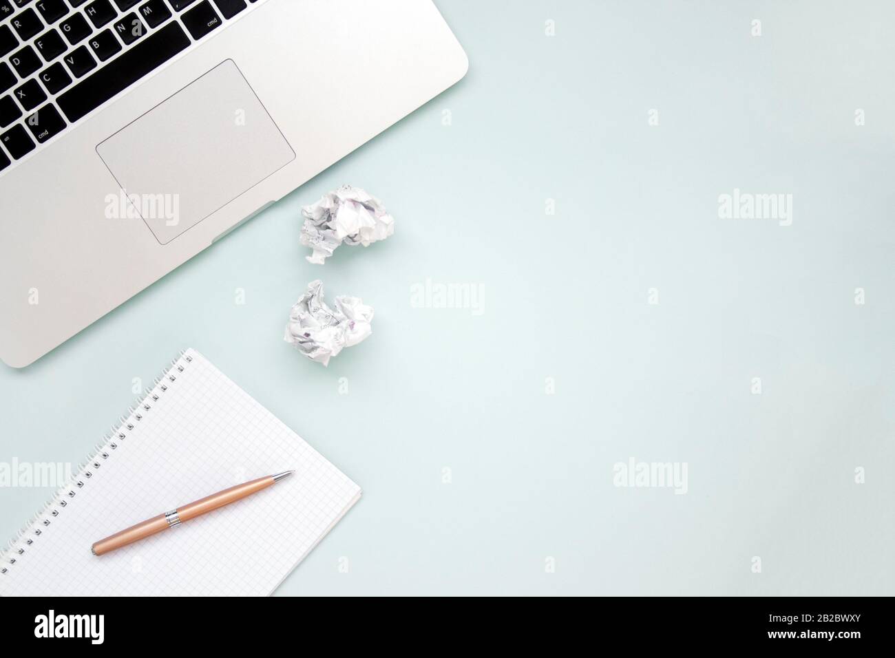 Creativу work concept. Laptop, notepad, crumpled paper and pen top view ...