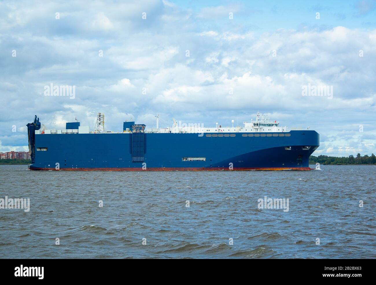 huge blue barge with large containers on board. shipping cargo ...