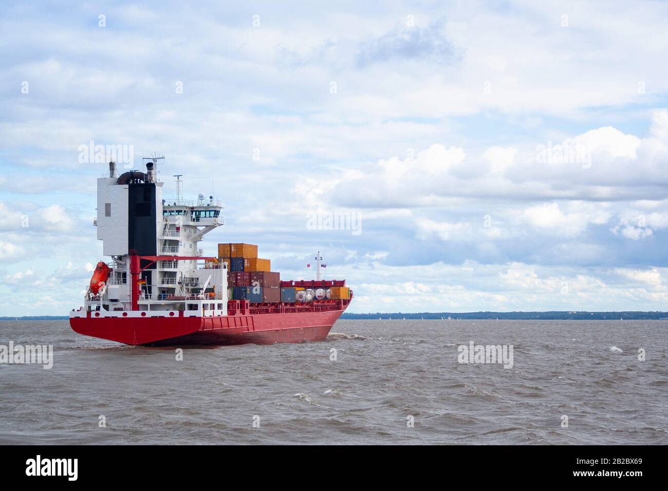 huge red barge with large containers on board. shipping cargo ...
