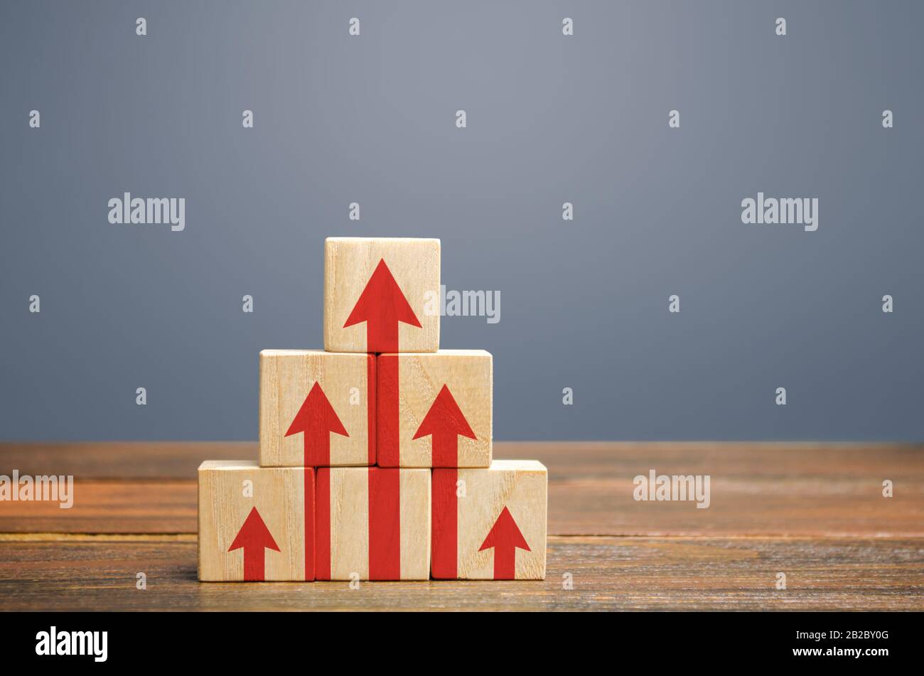 Wooden blocks with red up arrows. The process of successful development ...