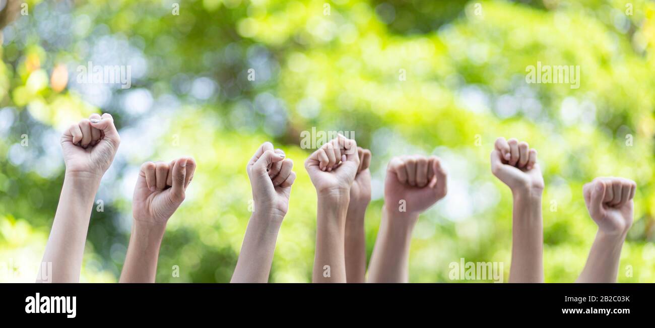 Panoramic group of hands business team raised fist air corporate ...