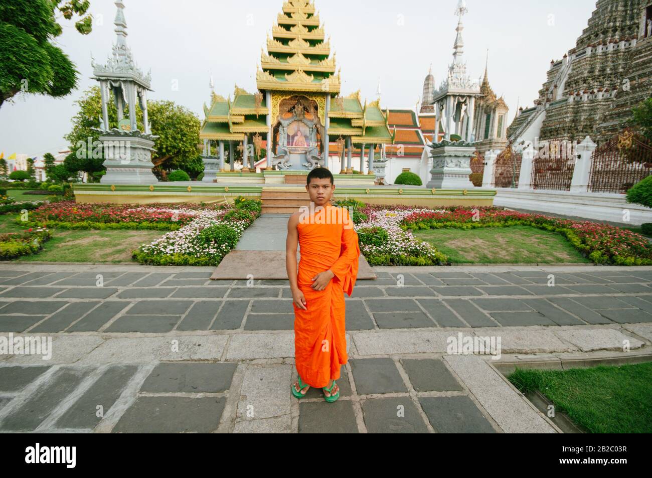 BANGKOK,THAILAND-MAY,06 2009: young monk poses for a photo in the wat ...